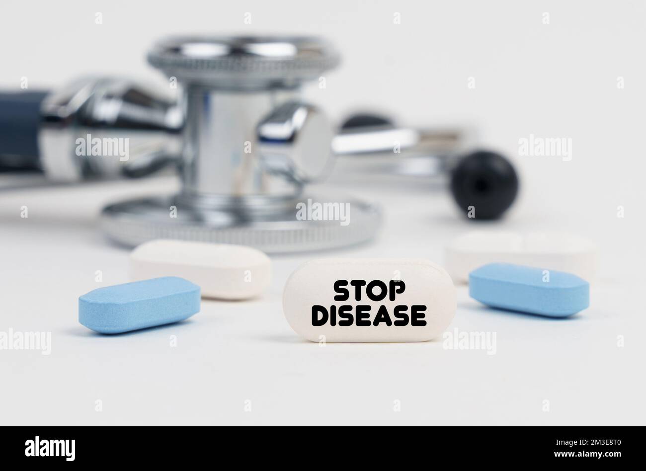 Medicine and health concept. On a white surface lie pills, a ...