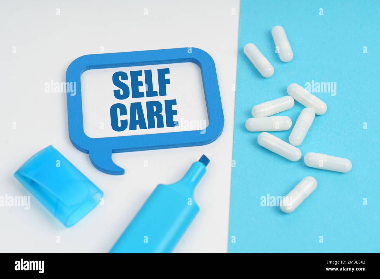 Medical concept. On the white and blue surface are a marker, tablets ...