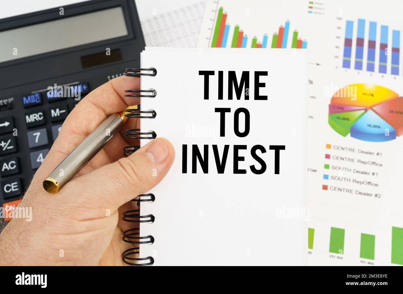 Finance and economics concept. The man is holding a pen and a notebook ...