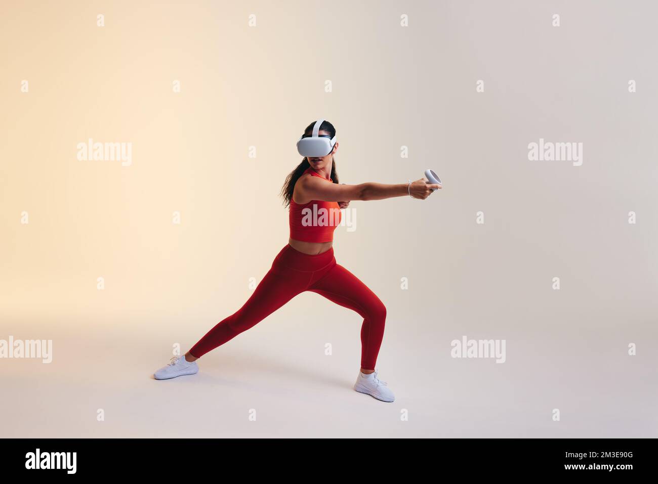 Young woman having an exercise session in virtual reality. Active young ...