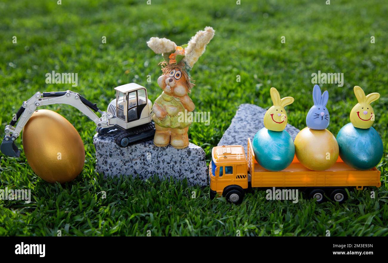 models of a toy excavator and a yellow dump truck with bright colorful ...
