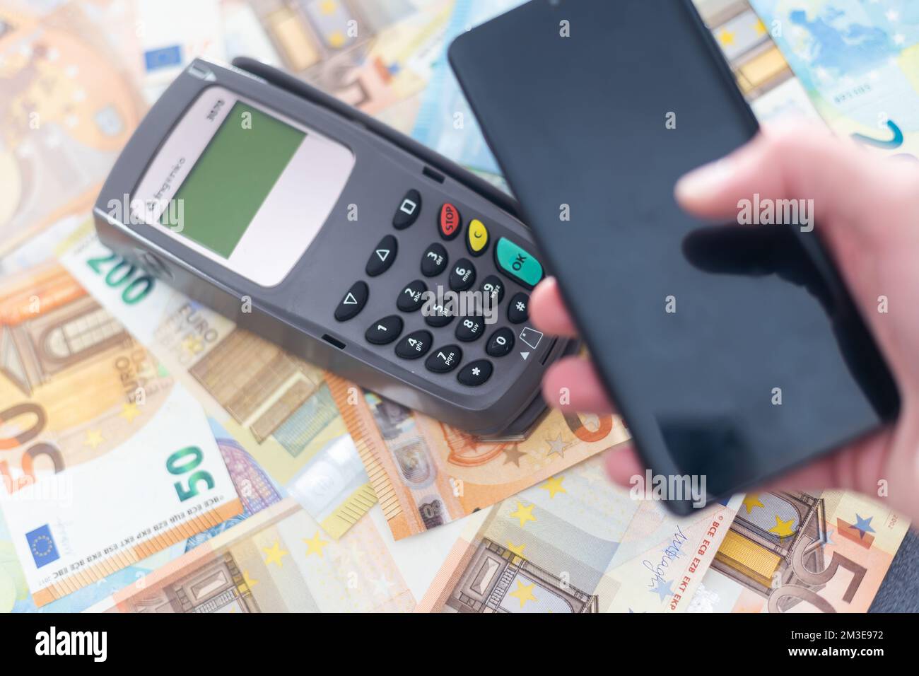 Banking terminal on euro banknotes background close up Stock Photo - Alamy