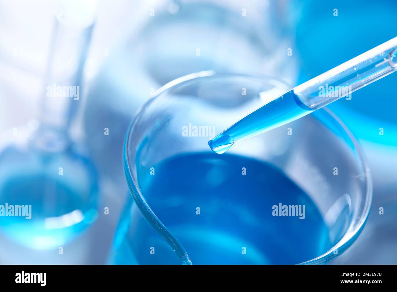 science lab with clear blue background and test tubes with blue ...