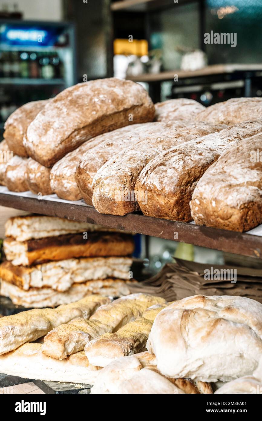 Loaves of bread on the shelves of the shop bakery counter. Fresh ...
