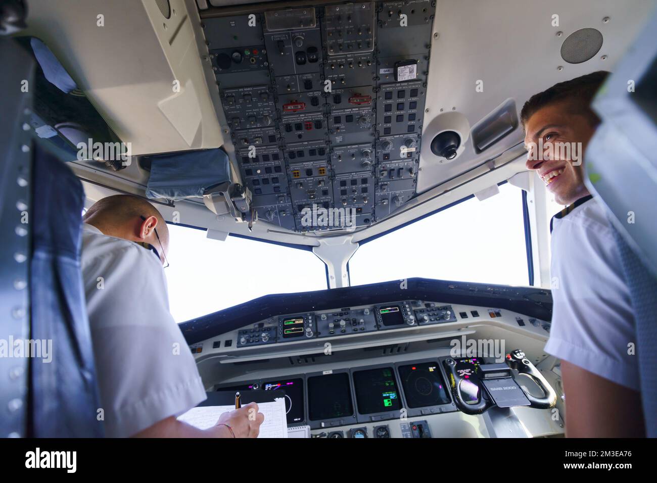 GENEVA - SEPTEMBER 16: Etihad Regional pilots in aircraft cockpit on ...