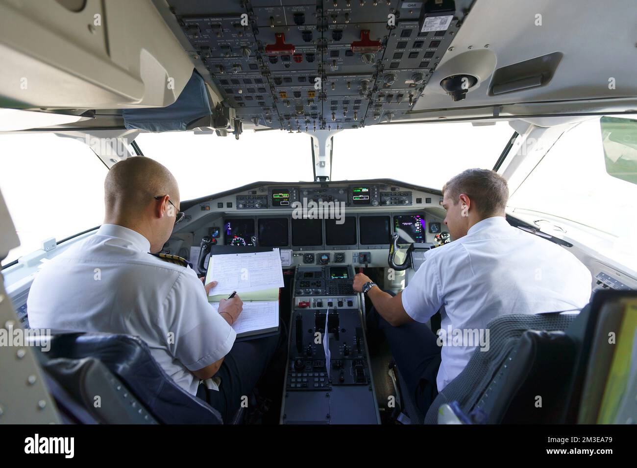 GENEVA - SEPTEMBER 16: Etihad Regional pilots in aircraft cockpit on ...