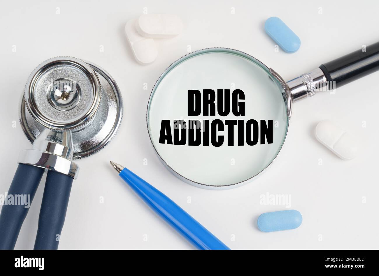 Medicine and health concept. On a white surface lie pills, a pen, a ...