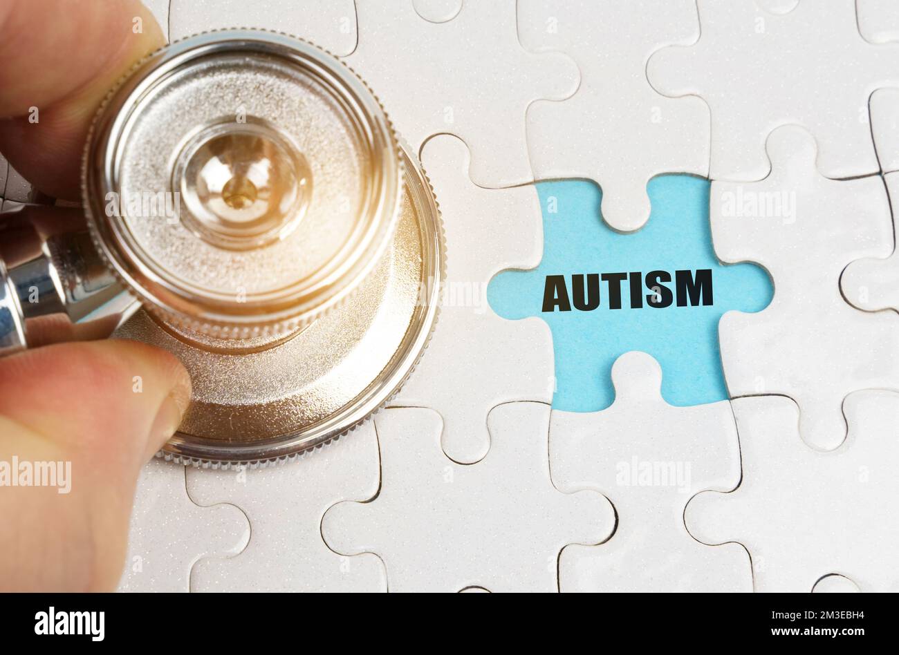 Medical concept. On puzzles a hand with a stethoscope, on a blue ...