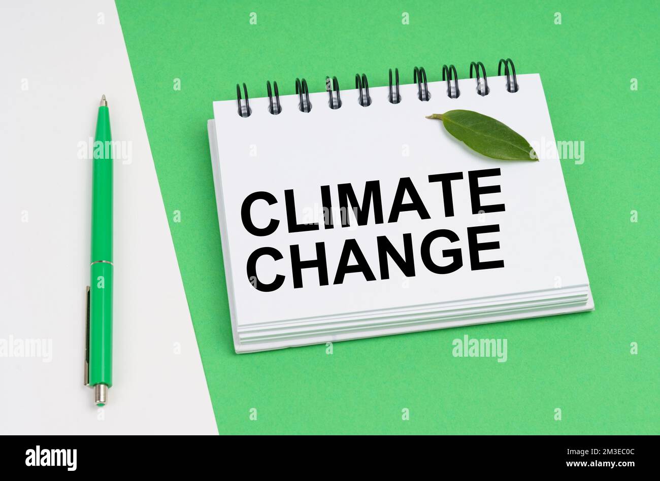 Ecological concept. On a white-green background lies a pen and a ...