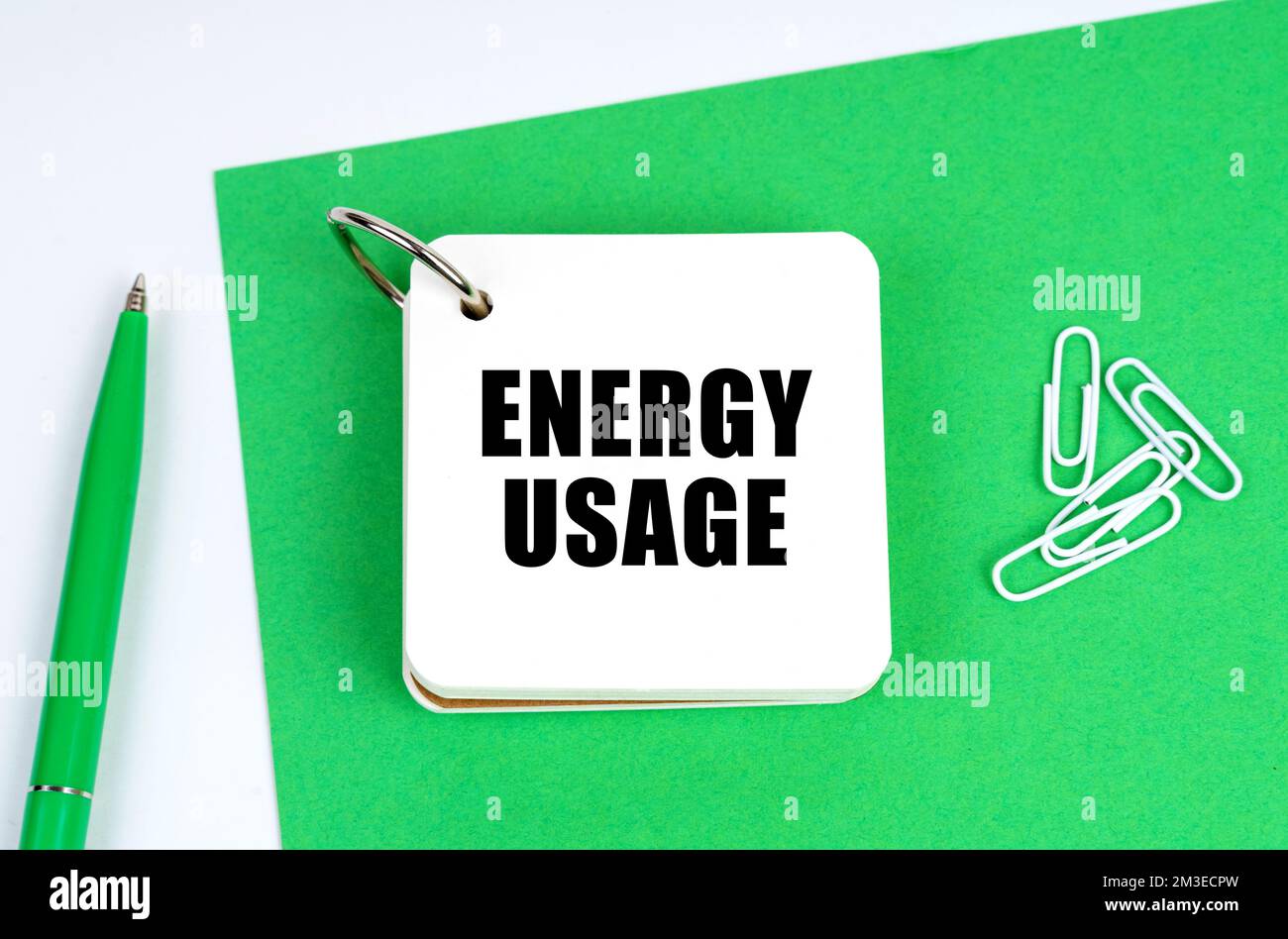 Ecology and industry concept. On a white surface lies a green sheet of ...