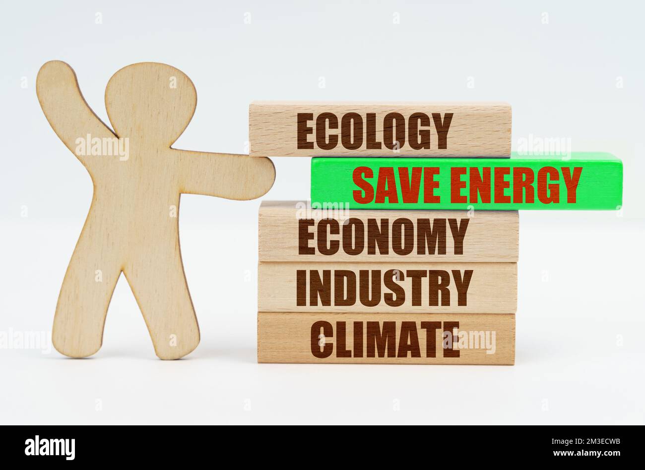 Ecology and industry concept. The wooden man moves the green block with ...