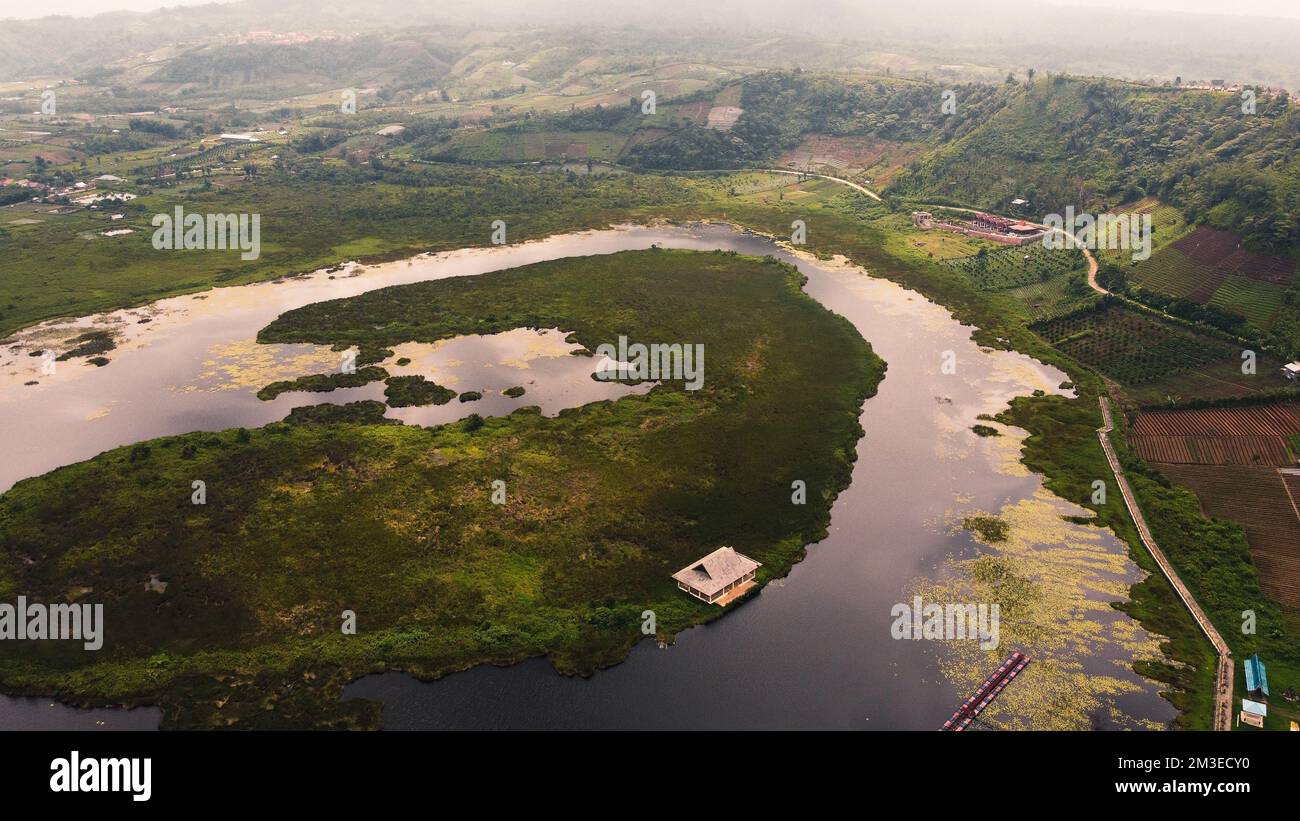 Charming aerial view of peaceful river flowing through green valley ...