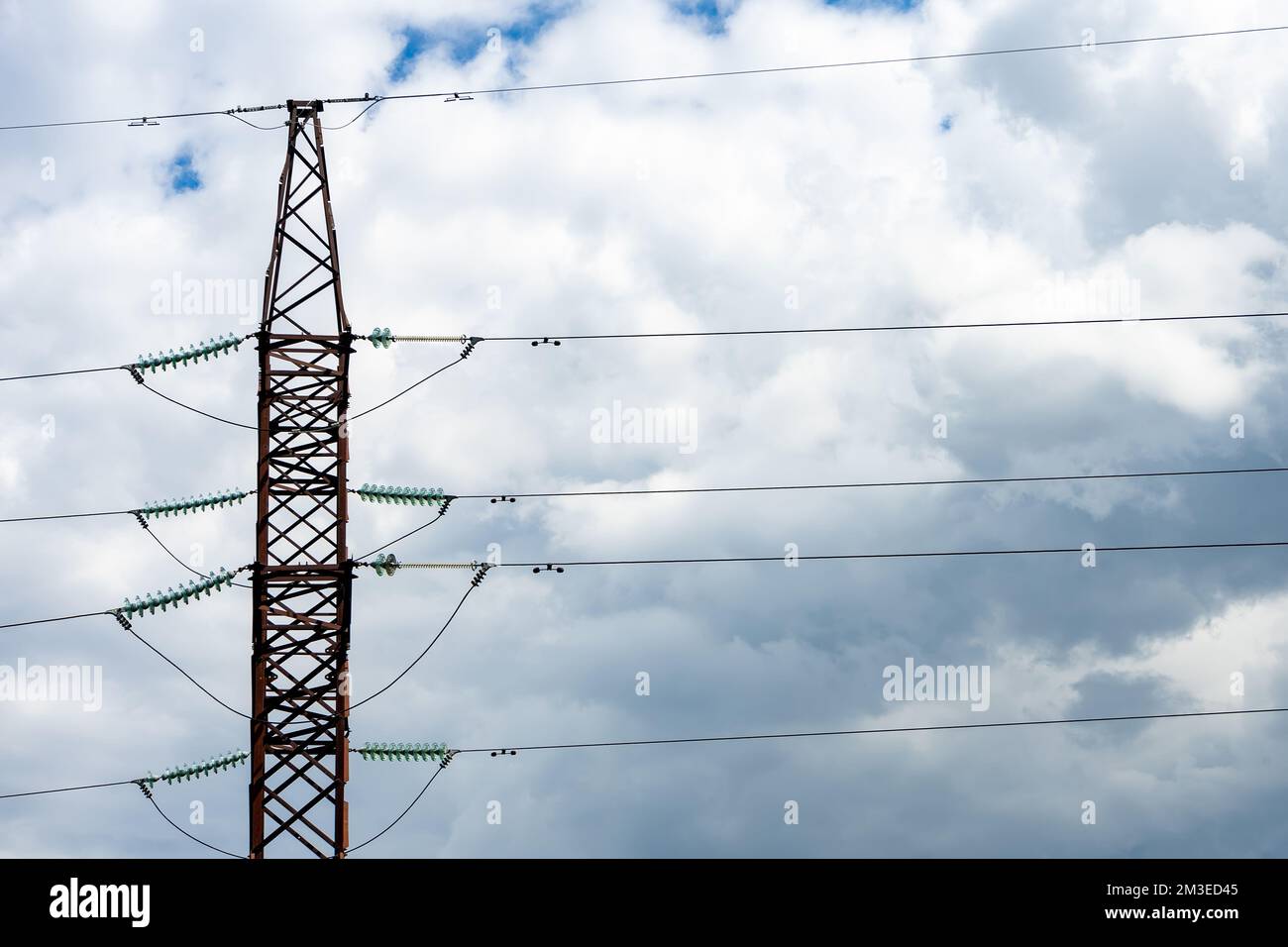 A support of a high-voltage electric line on a background of clouds ...