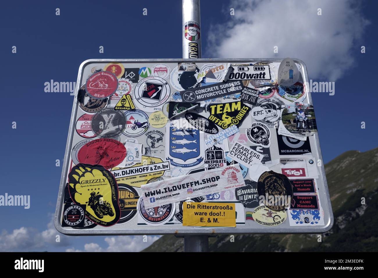 Colorful stickers on a street sign Stock Photo - Alamy