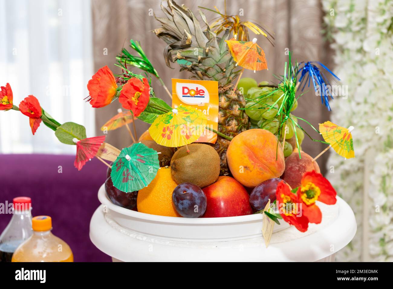 Many different sweet ripe fruits on the festive table in a fruit vase ...
