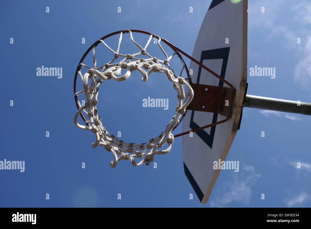 Basketball hoop seen from below against the sun Stock Photo - Alamy
