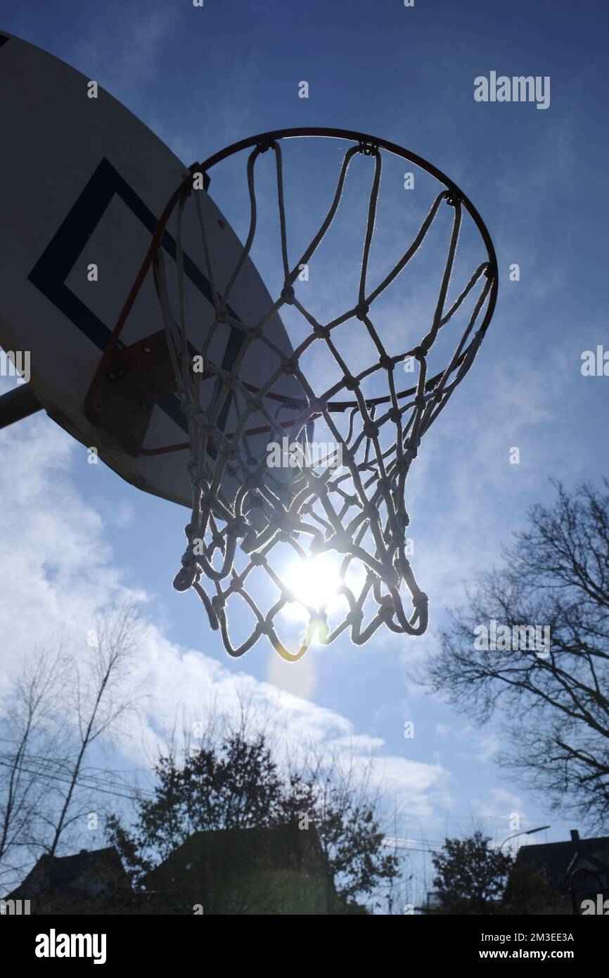 Basketball hoop seen from below against the sun Stock Photo - Alamy
