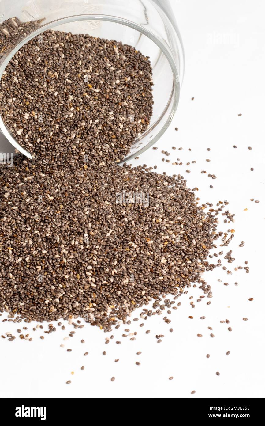 Healthy and diet food, Chia seeds are pouring out from glass jar over ...