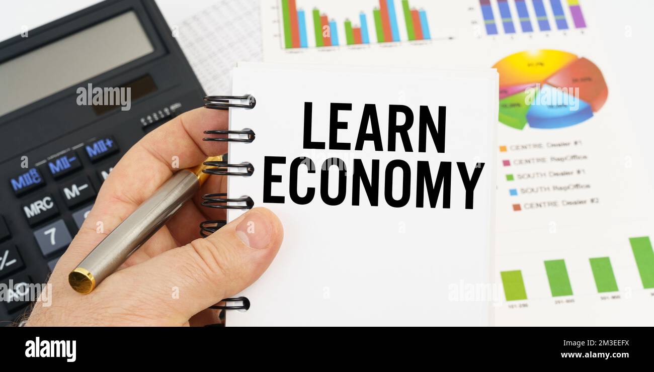 Finance and economics concept. The man is holding a pen and a notebook ...