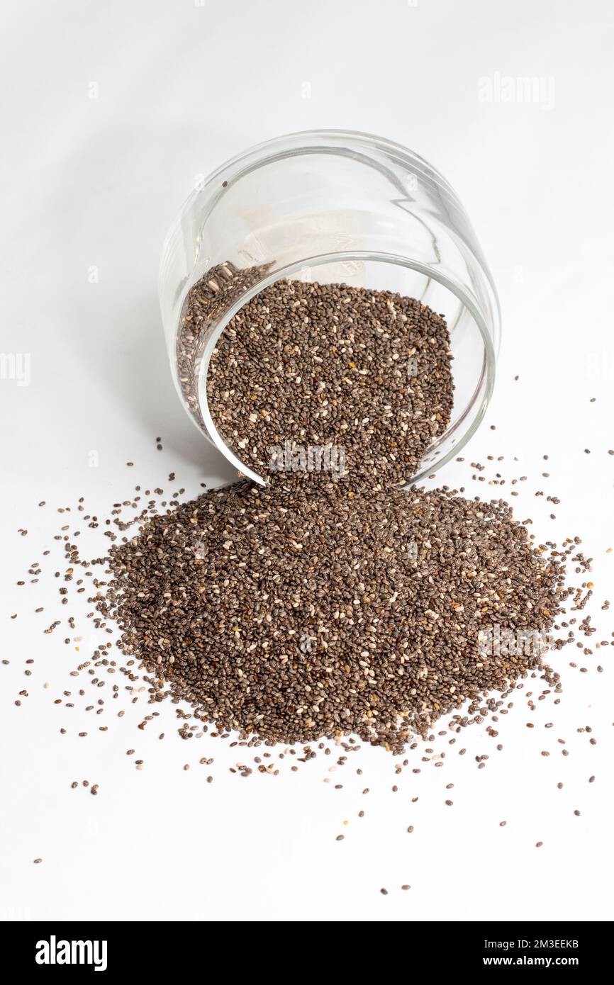 Healthy and diet food, Chia seeds are pouring out from glass jar over ...