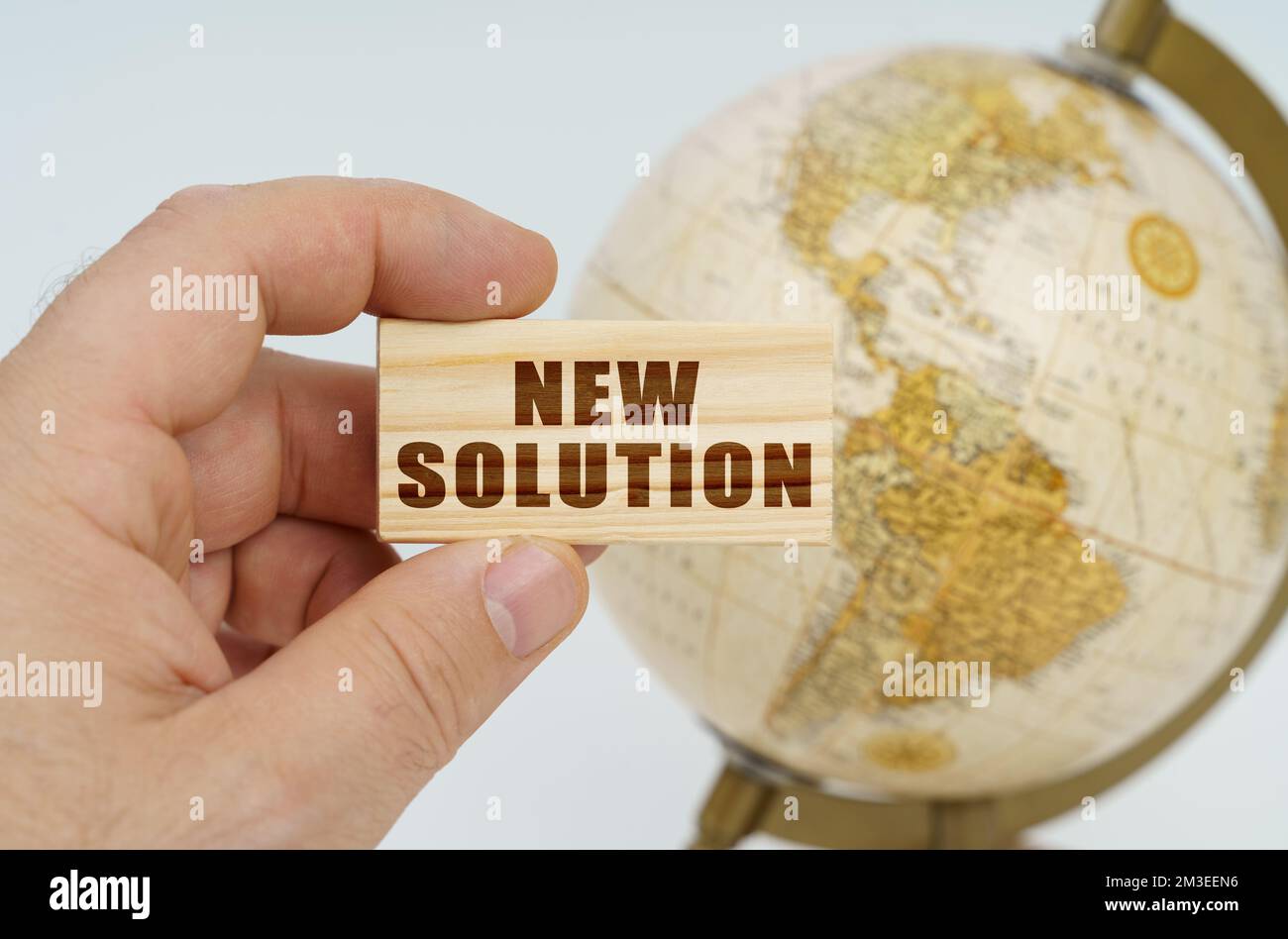 Globalization concept. A man holds in his hand a wooden plate on which ...