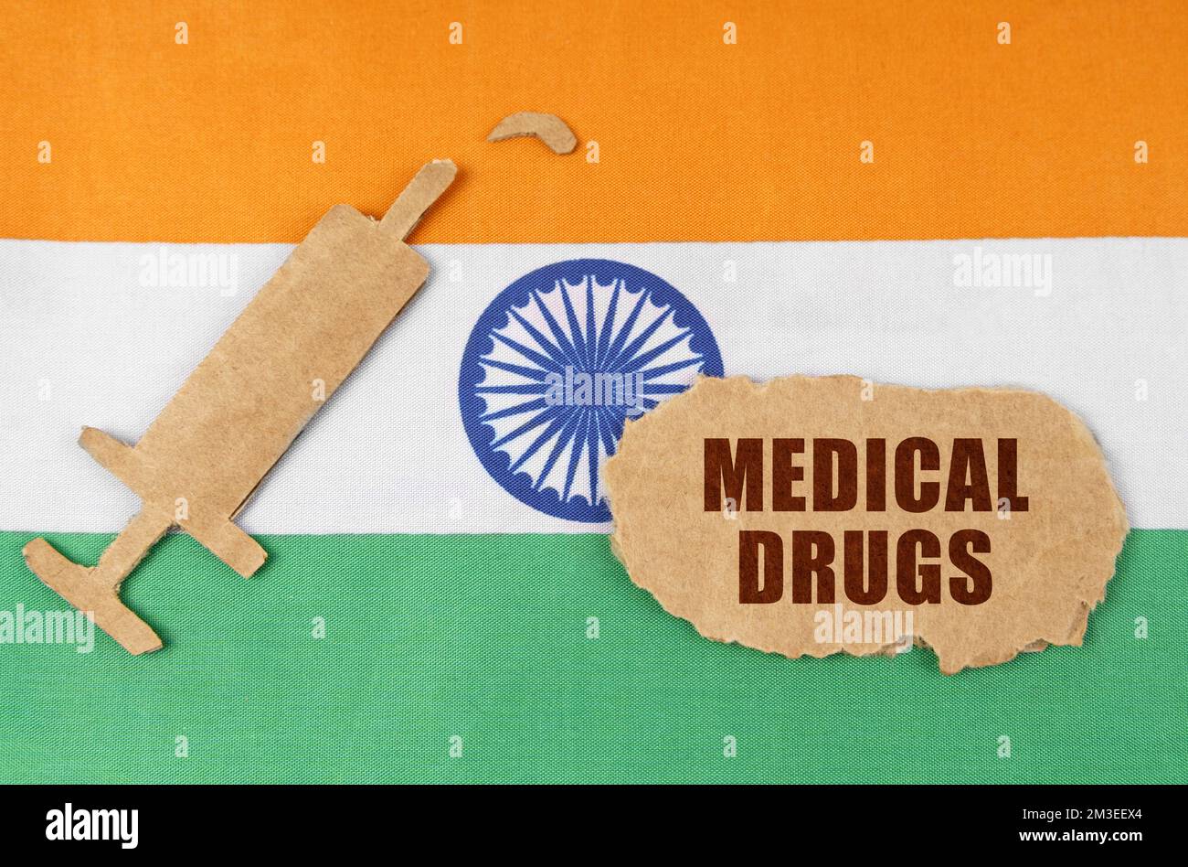 Medical concept. On the flag of India, a cardboard figure of a syringe ...