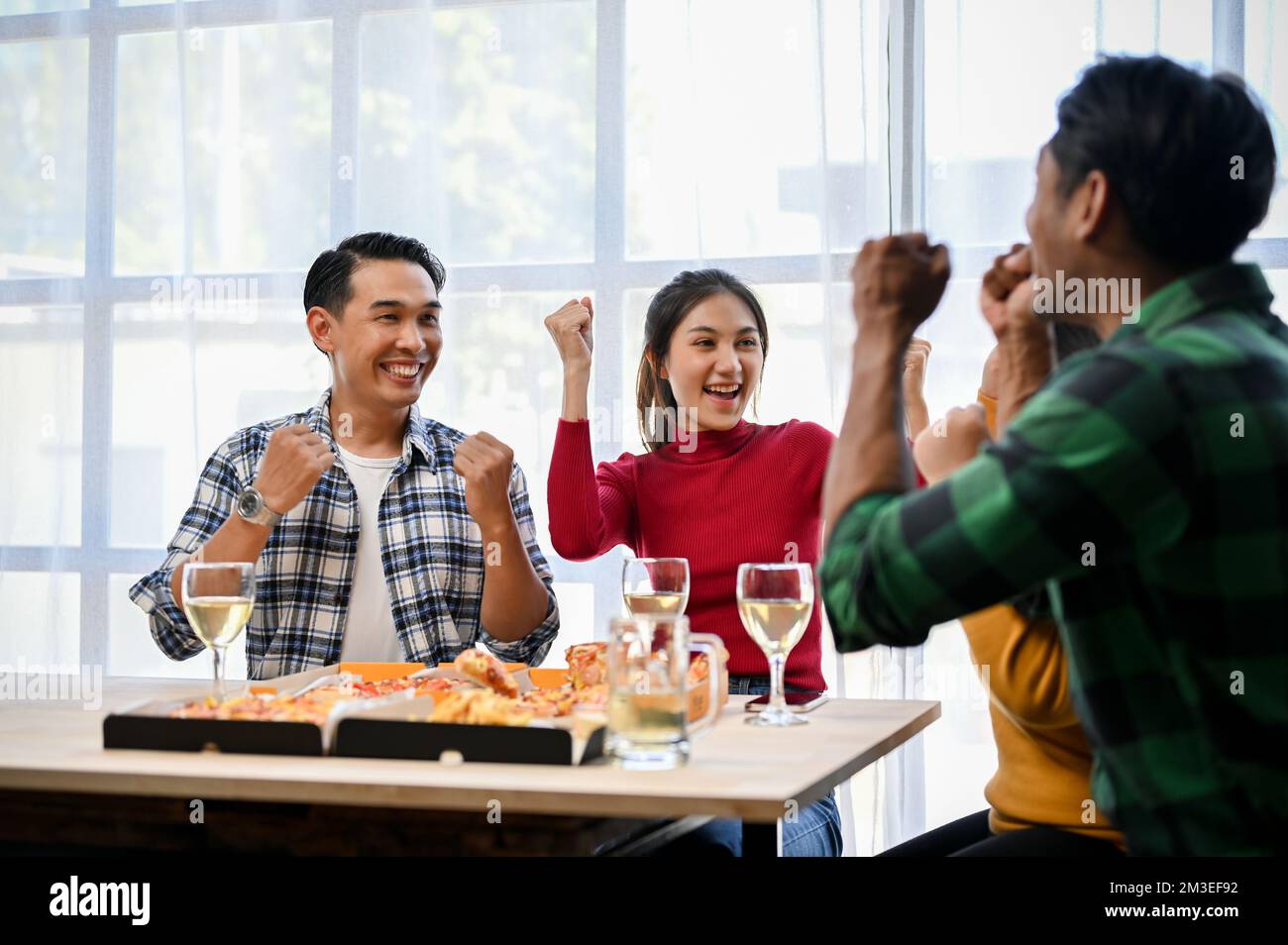 Diversity of happy Asian friends celebrating victory, showing clenched ...