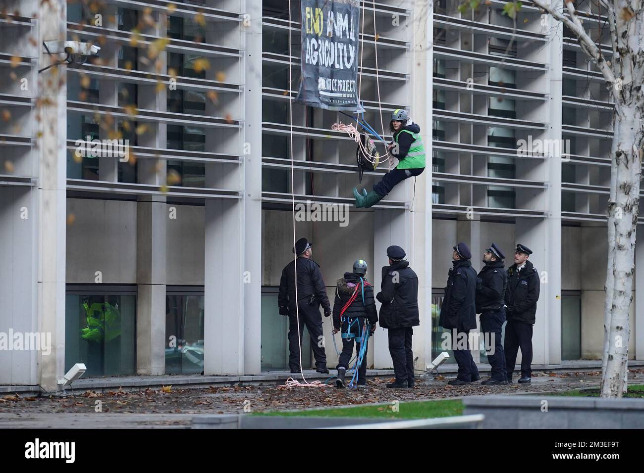 Police talk to protesters who unfurled a banner about animal rights ...