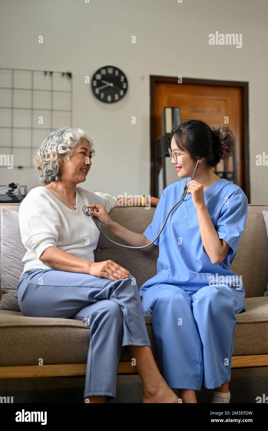 Portrait, Professional Asian female doctor visiting her retire female ...