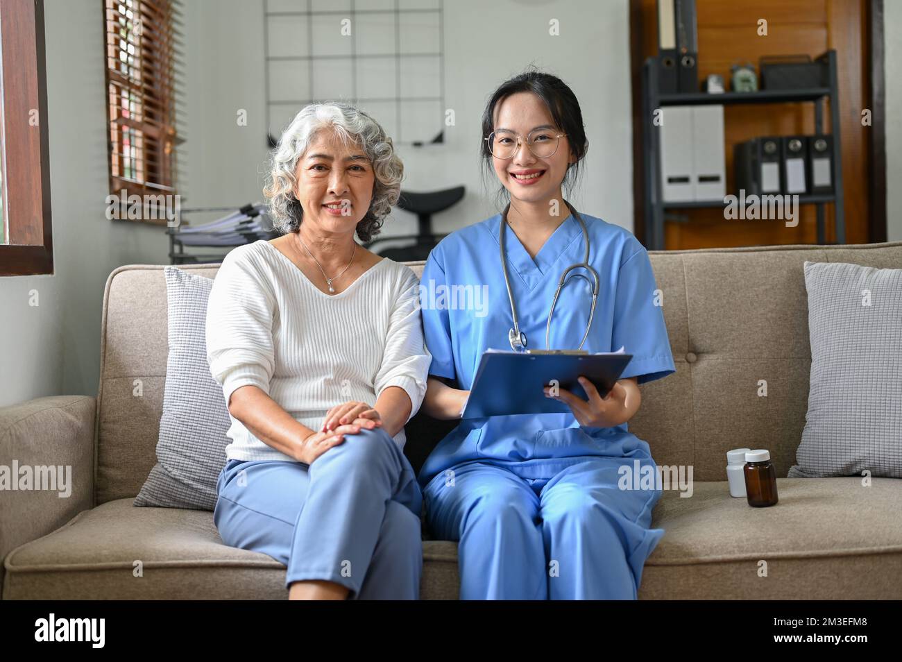 Portrait of a happy 60-year-old elderly woman and a female doctor in ...