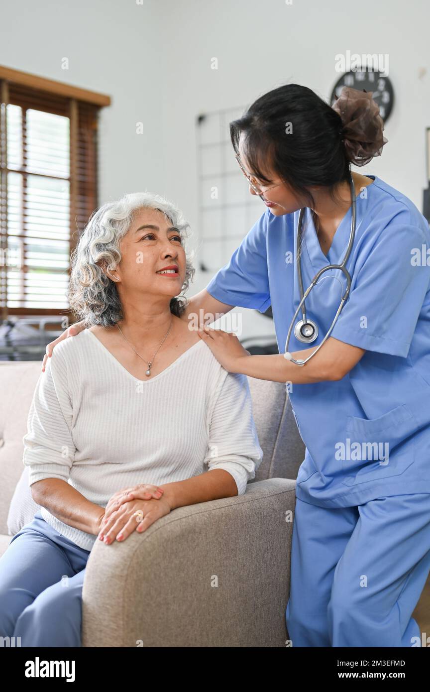 Portrait, Caring and kind young Asian female doctor or nurse talking ...