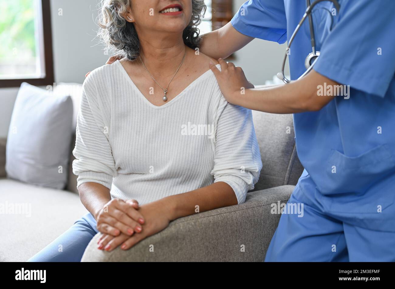 Cropped Image A Female Caregiver Or Nurse Visiting A Sick 60 Year Old