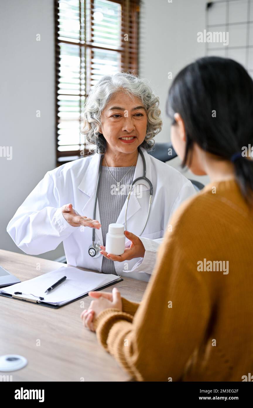 Portrait, Professional Asian female doctor explaining and giving a ...