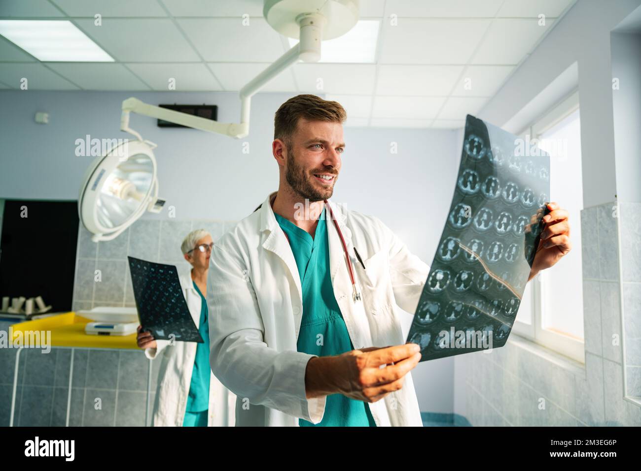 Radiologist doctor consulting with colleagues an x-ray scan in hospital ...