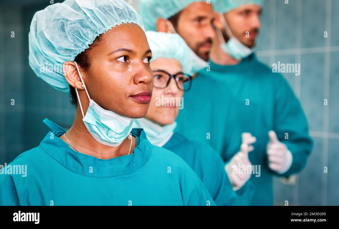 Portrait of a successful medical surgeon team inside operating room ...