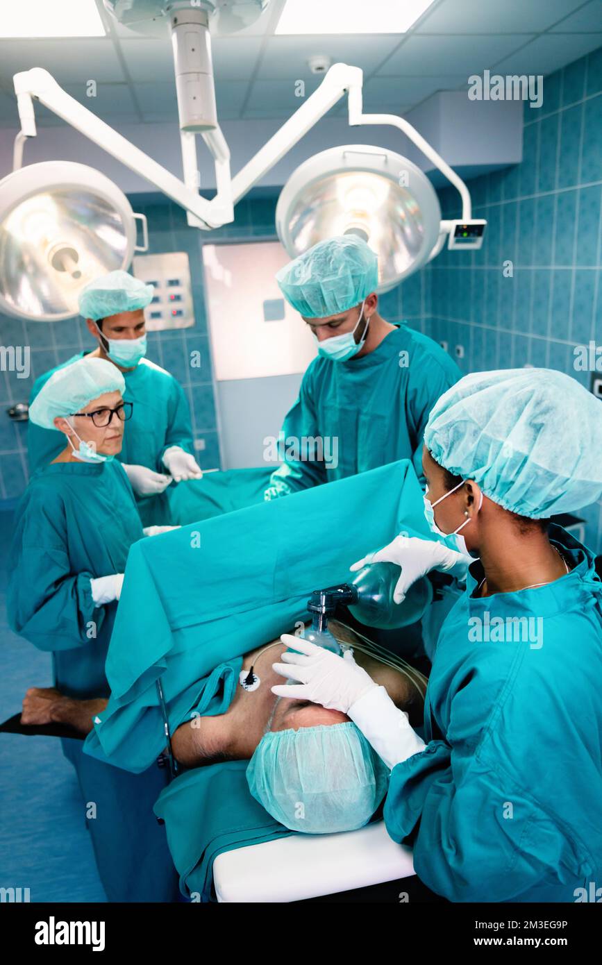 Group of surgeon team at work in operating room in hospital Stock Photo ...