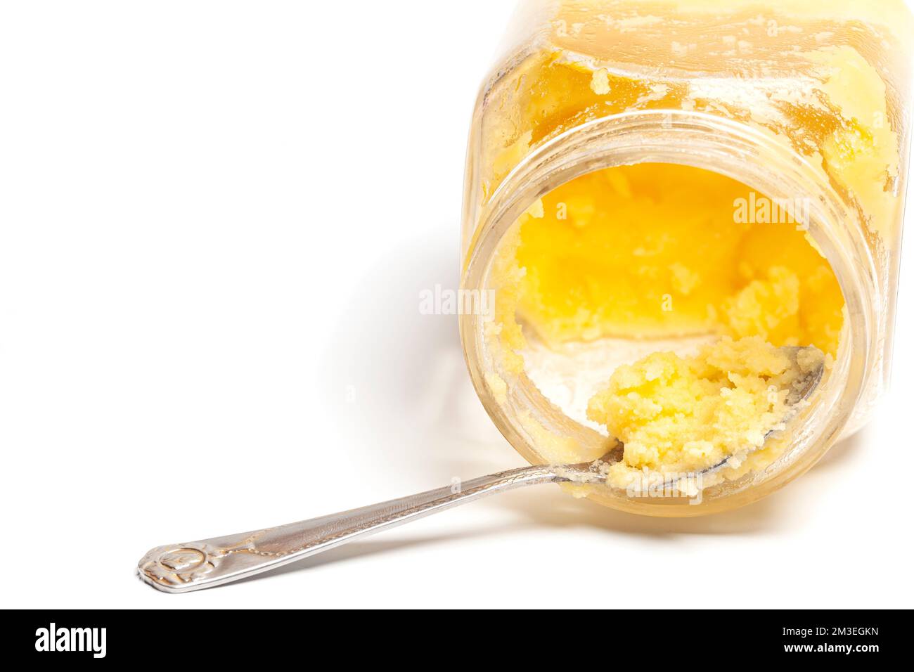 Ghee in jar and spoon isolated on white background Stock Photo - Alamy
