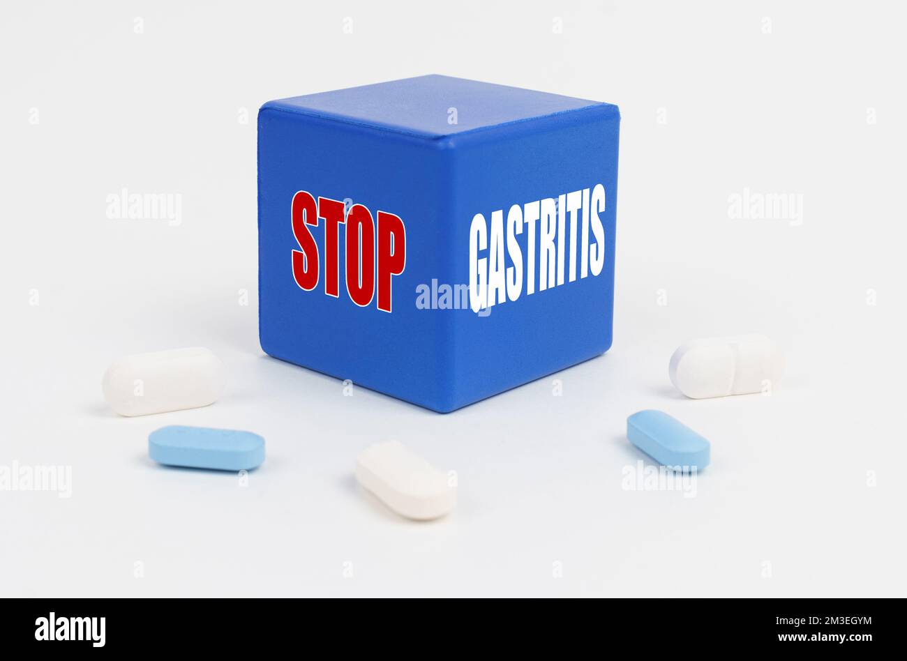Medicine and health concept. On a white surface are pills and a blue ...