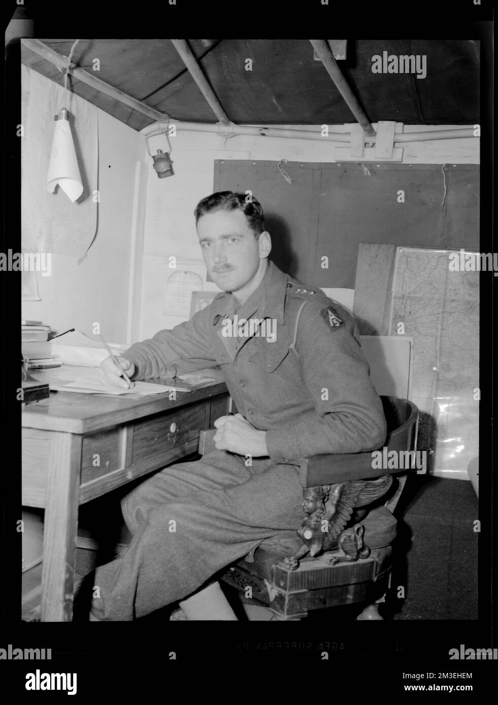 Man in uniform posing at desk with pen , Military personnel, Desks ...