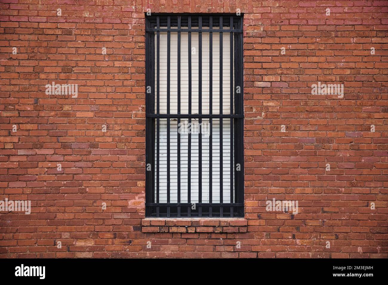 A window with black metal bars on a brick building Stock Photo - Alamy