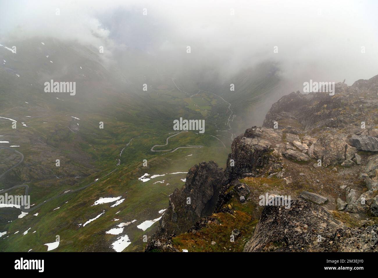 This is an aerial view from Mount Dalsnibba to Geiranger through clouds ...