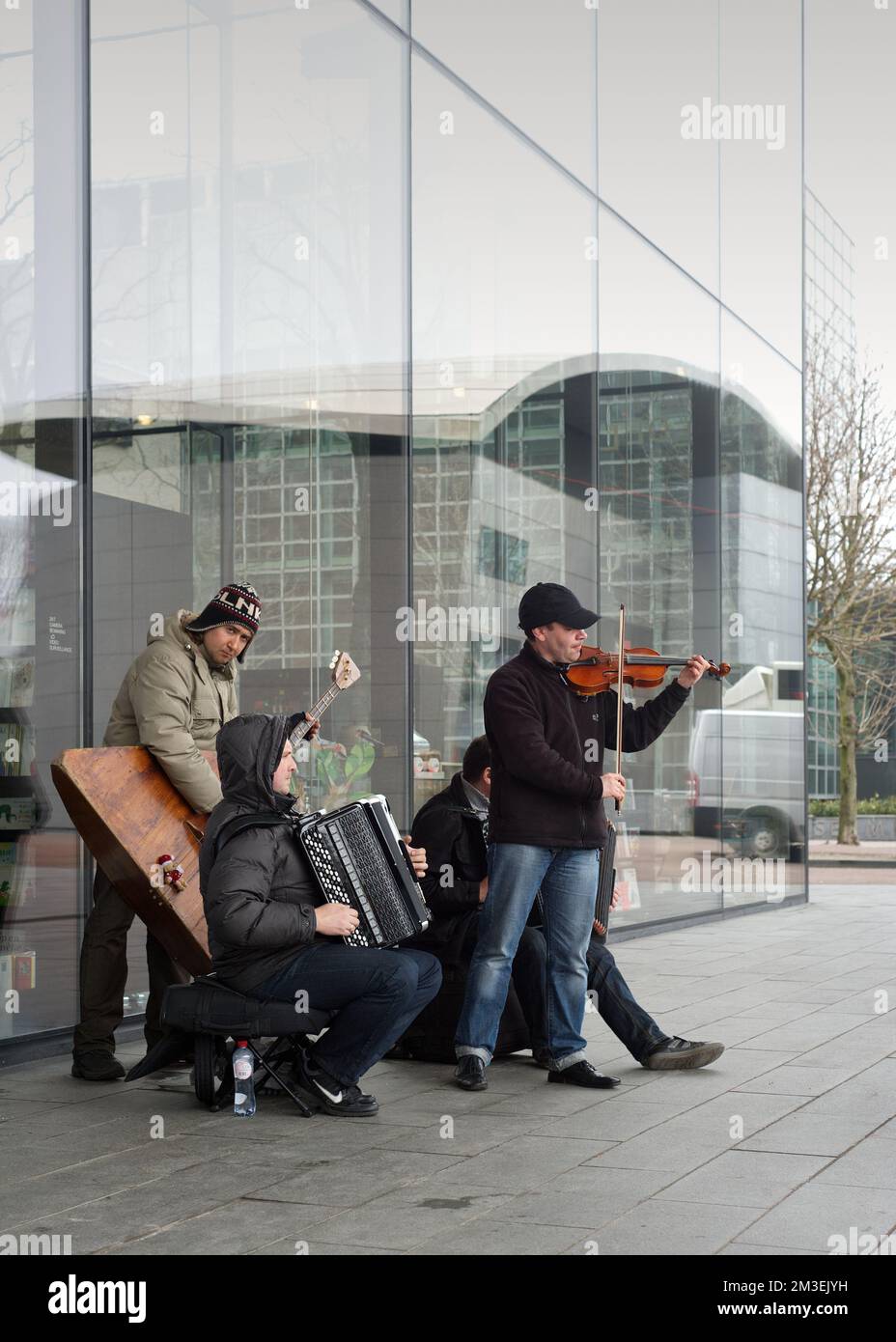 Folk music quartet performing on the street in Amsterdam, Netherlands ...