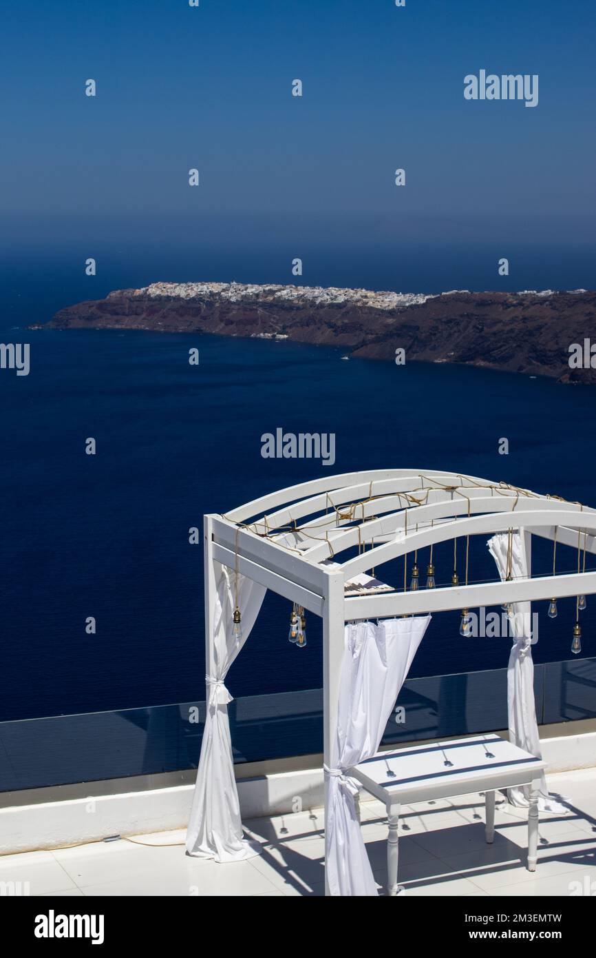 A vertical high-angle of a wedding canopy with seascape background ...