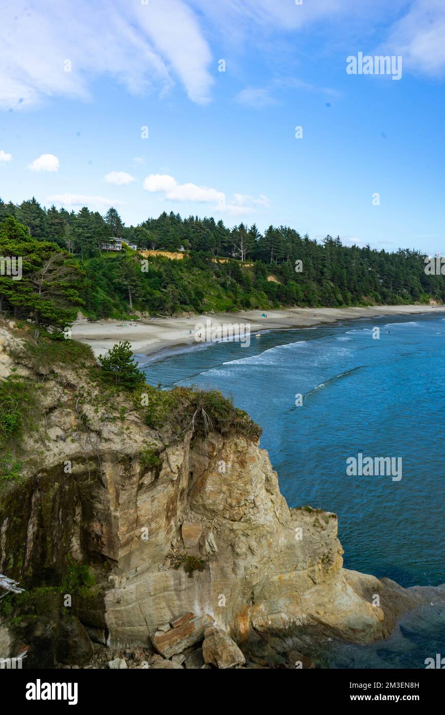 A vertical shot of a cliff on the beach shore under a blue sky Stock ...