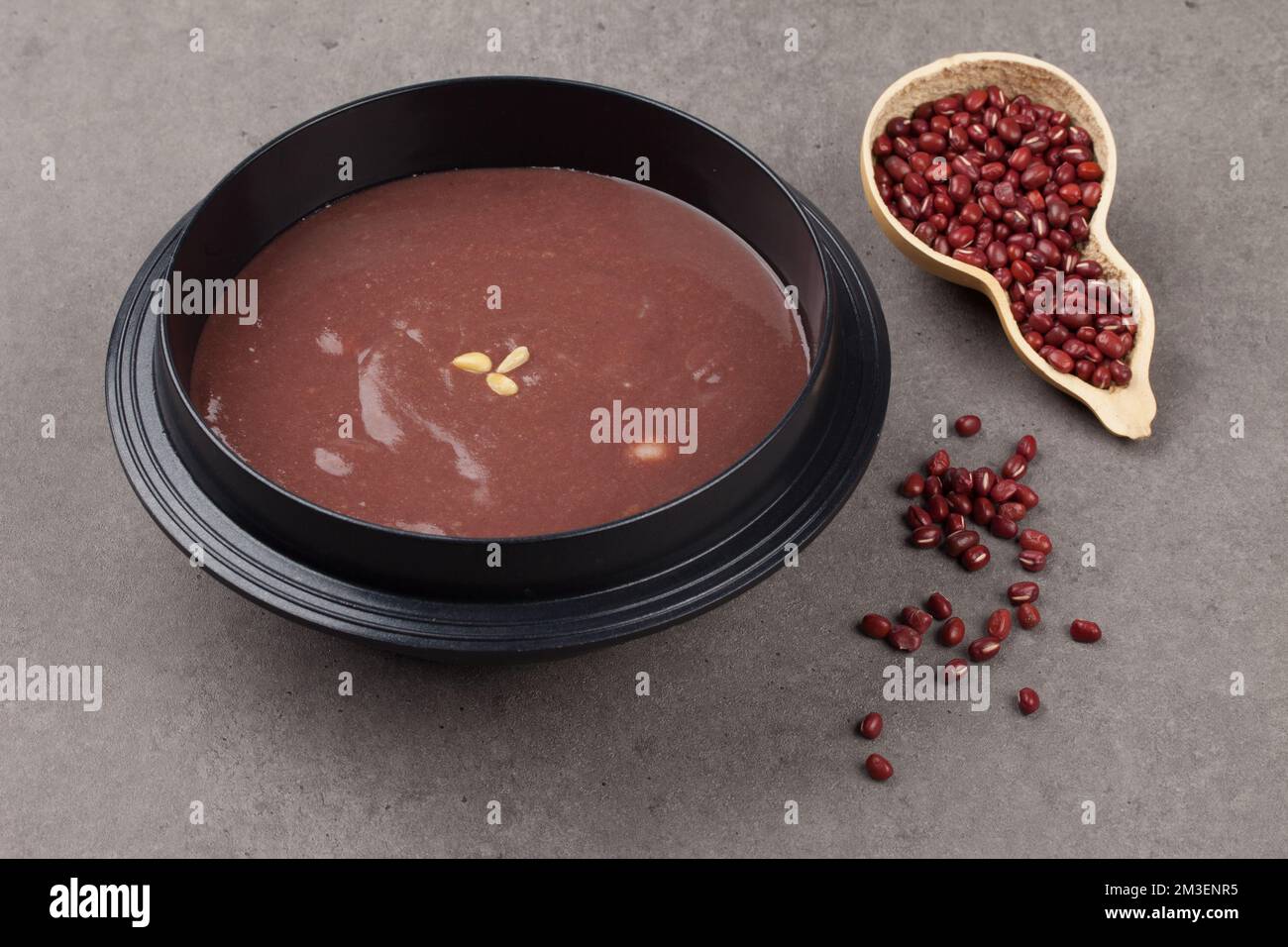 Boil the red beans thoroughly and mash them, and cook the rice porridge ...