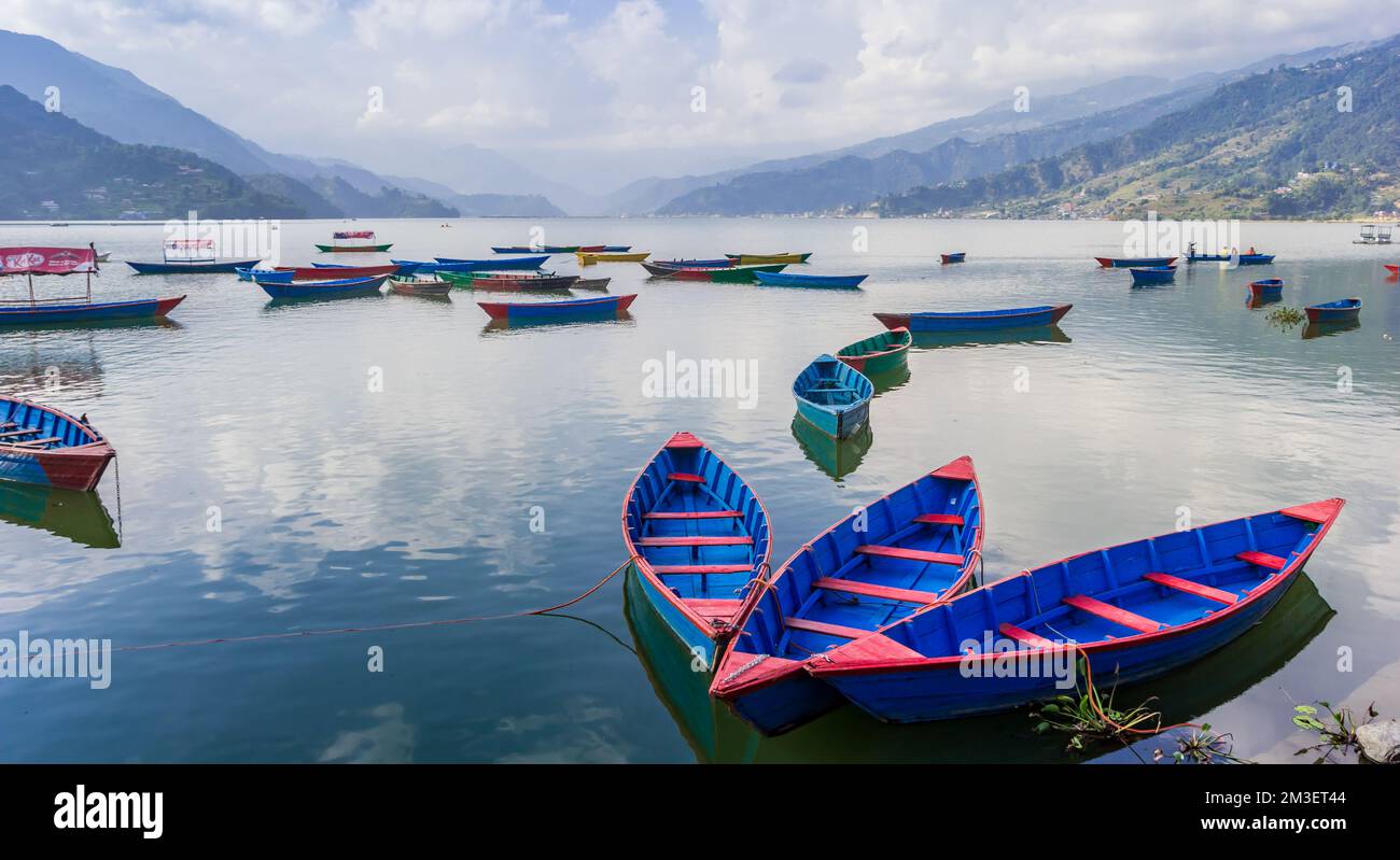 Phewa lake with traditional wooden boats in Pokhara, Nepal Stock Photo ...