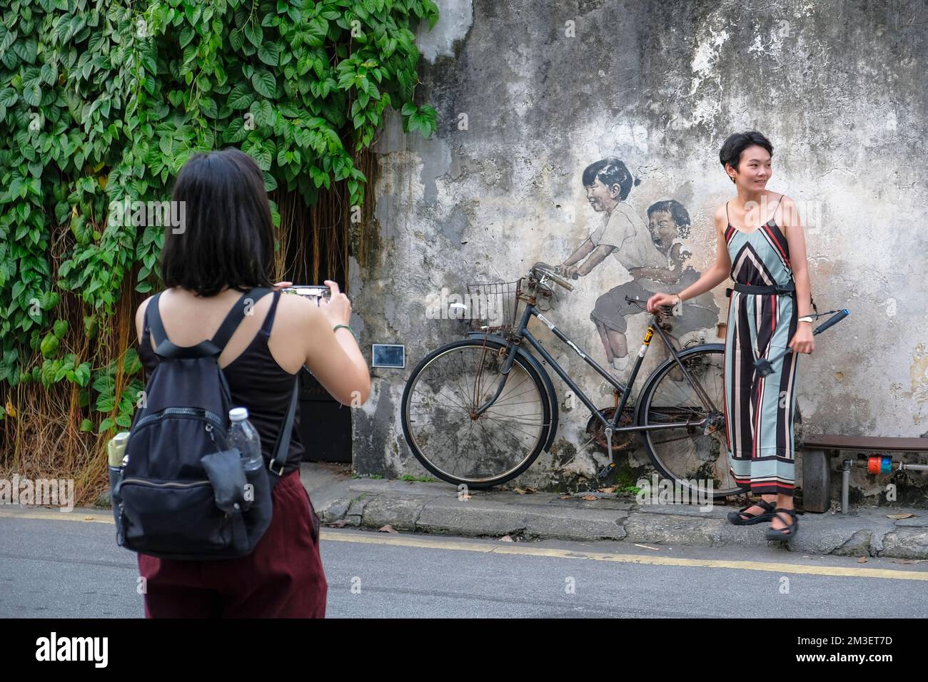George Town, Malaysia - November 2022: Tourists taking pictures with a ...