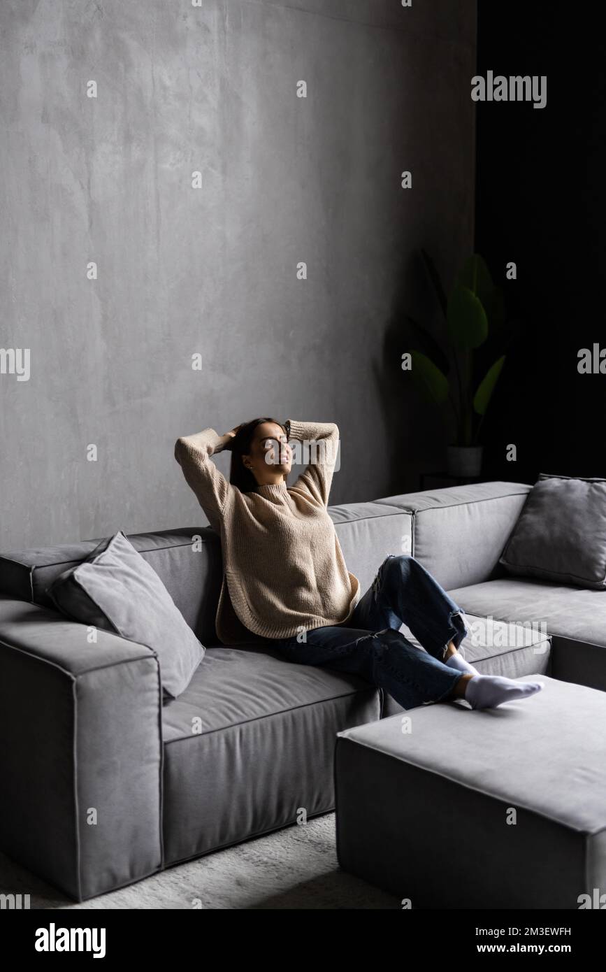 Full length peaceful woman with closed eyes resting on couch, leaning ...