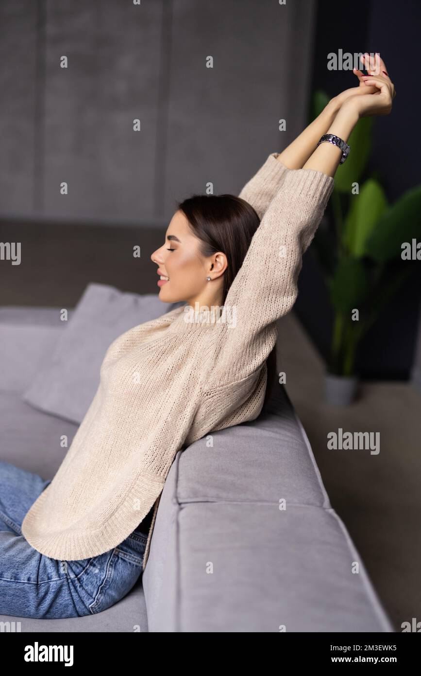 Full length peaceful woman with closed eyes resting on couch, leaning ...