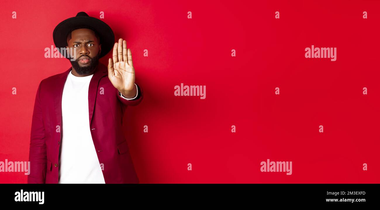 Serious and concerned Black man stretching hand to stop you, prohibit ...
